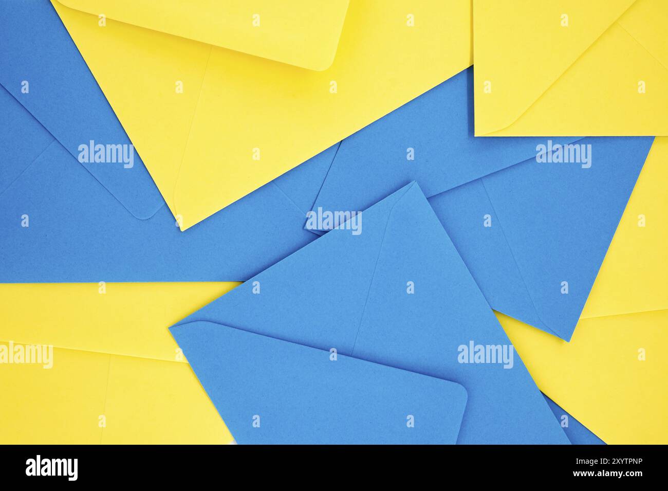 Blue and yellow paper envelopes organized in a symmetrical pattern ...