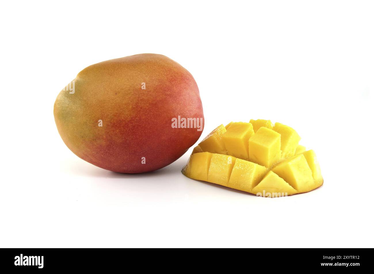 Ripe mango with red and yellow skin near cut half mango with the flesh ...