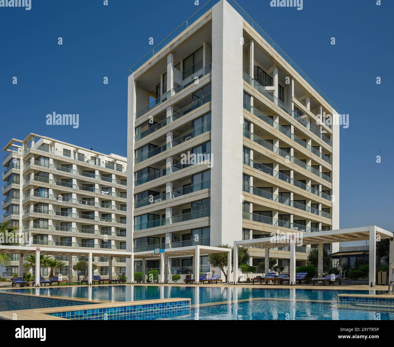 Modern apartment building or house exterior with lawn yard and swimming ...
