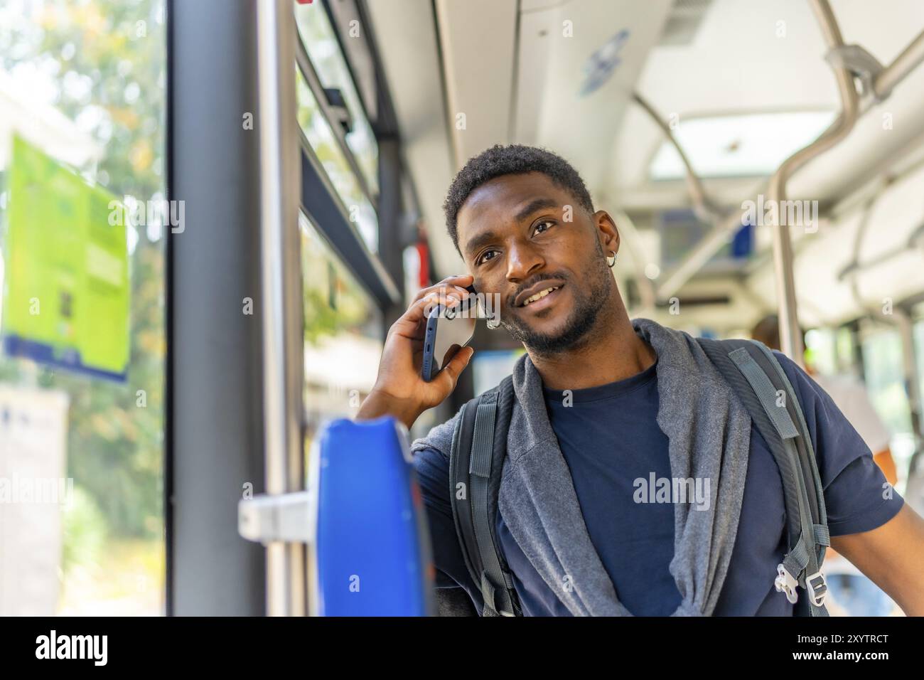 African young man talking to the mobile sitting in an urban bus Stock ...
