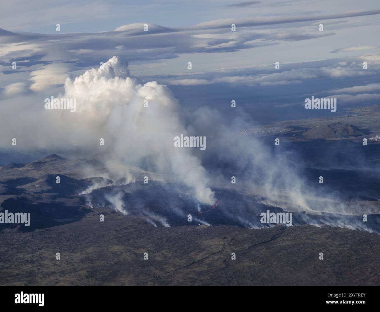 Volcanic eruption, smoke plumes and lava field, aerial view, near ...