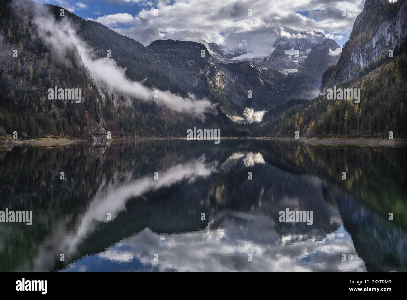 The Vordere Gosausee in autumn. In the background, the Dachstein ...