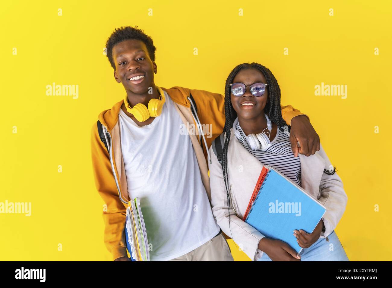 Studio portrait with yellow background of two male and female ...