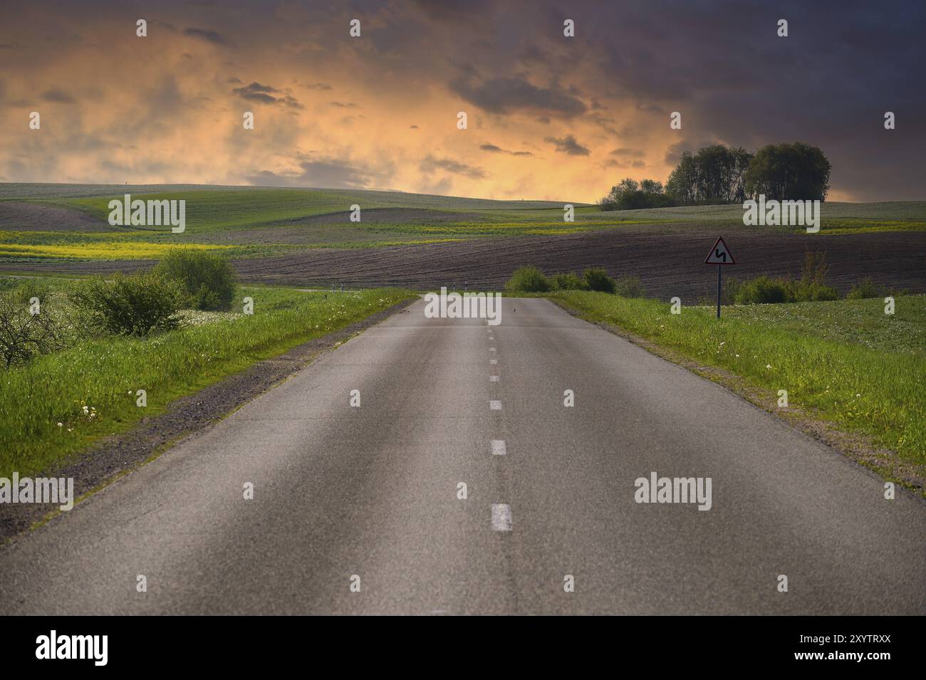 Empty two lane asphalt road running through a serene and open ...