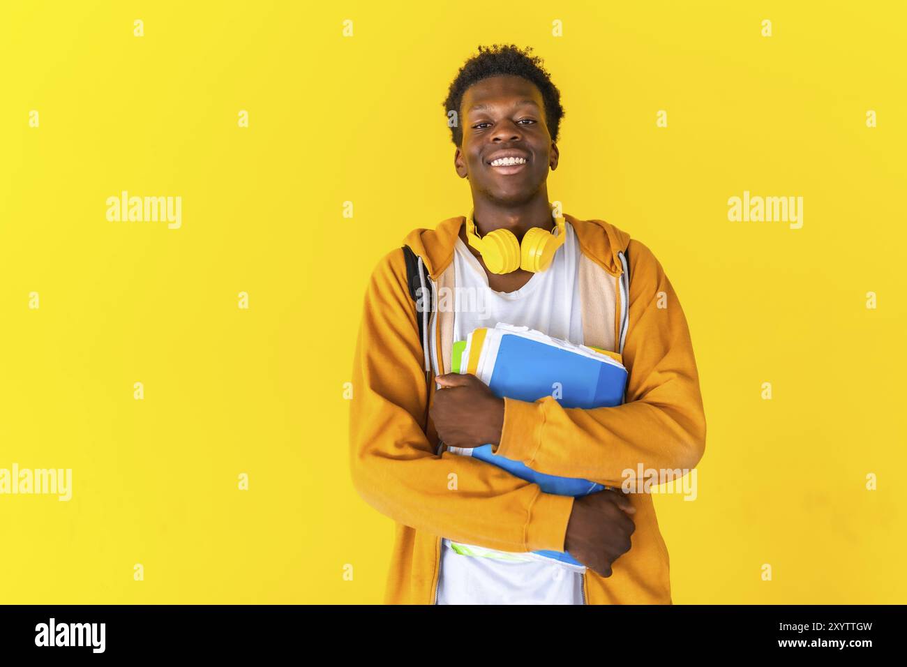 Studio portrait with yellow background of an african american cheerful ...