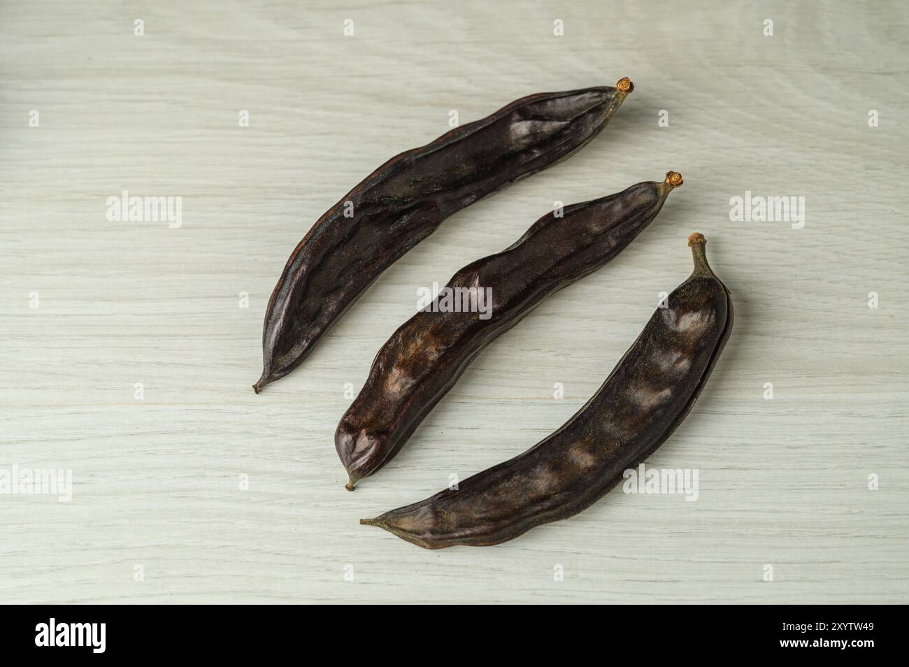 Carob carob fruit and seeds on white background Stock Photo - Alamy