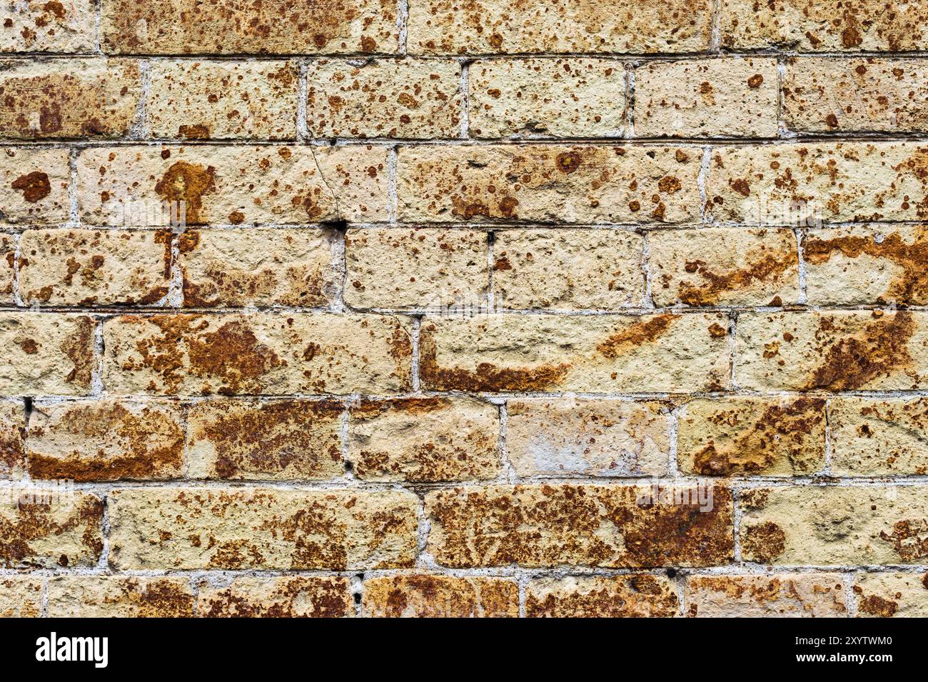 Background wall from an ancient yellow vintage brick with rusty ...
