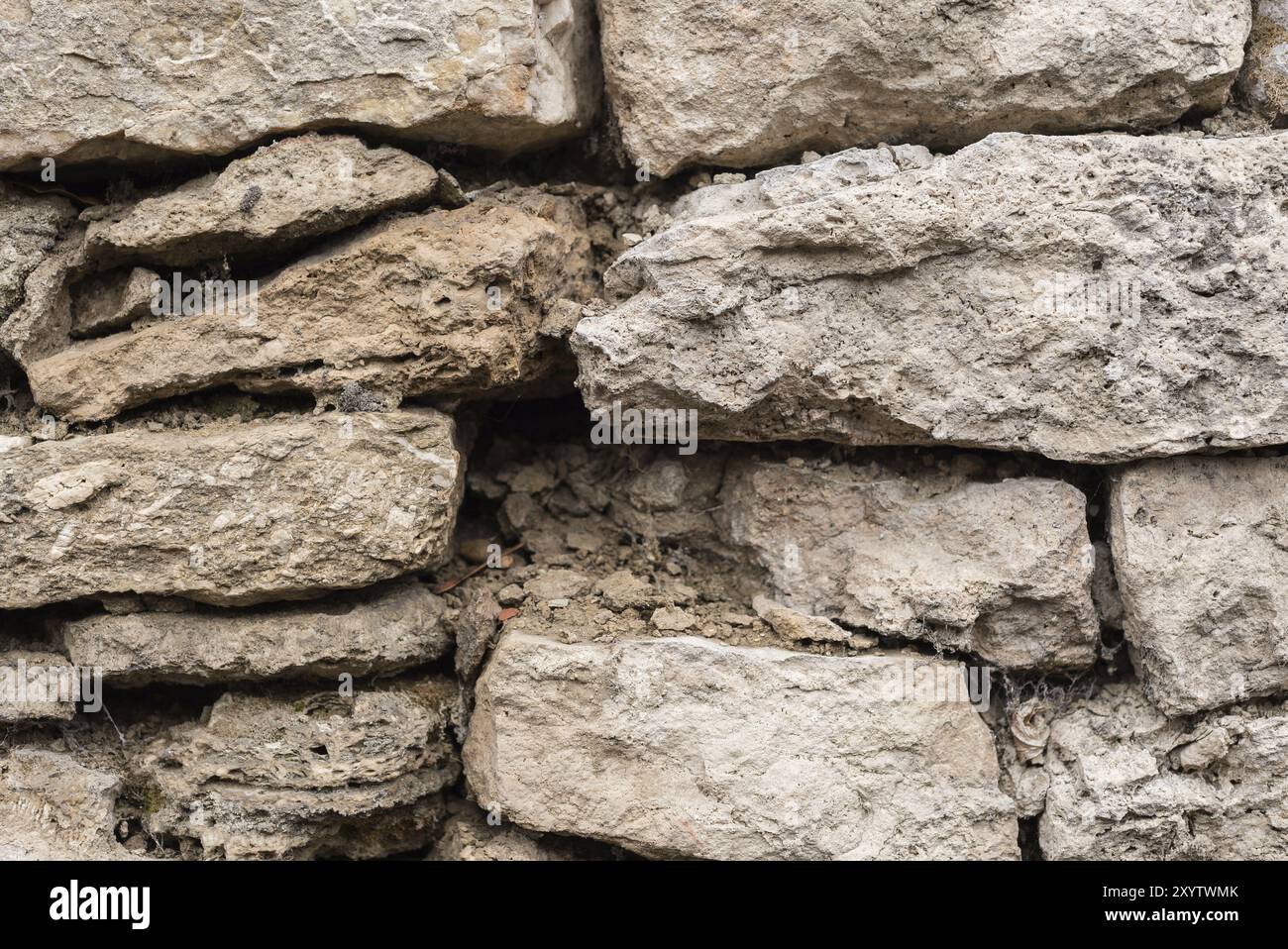 Close-up textured background is an irregular natural stone wall made of ...