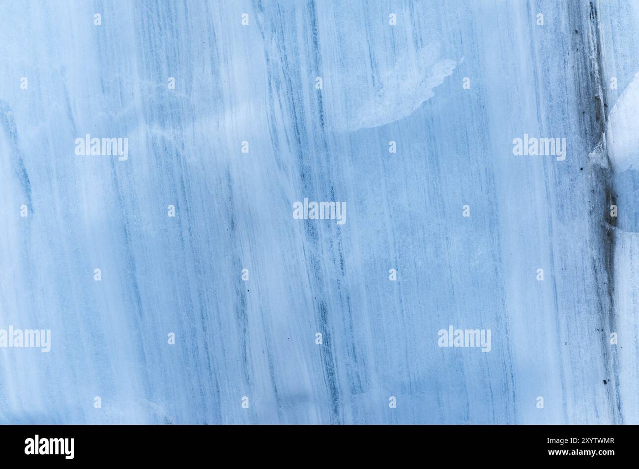 Close-up wall of a centuries-old glacier with a structure of stripes ...