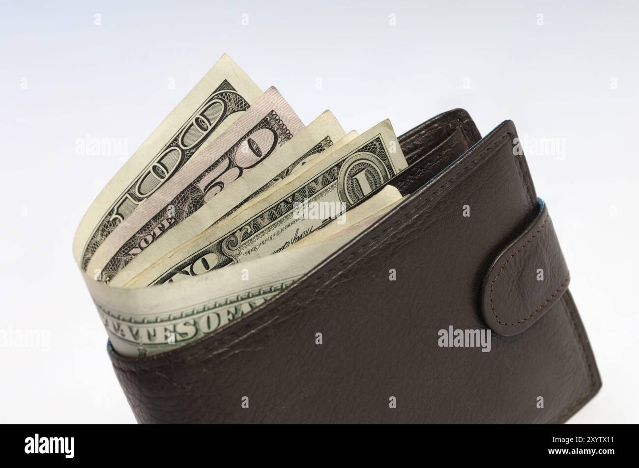 Brown leather wallet with US dollar bills sticking out of it Isolated ...