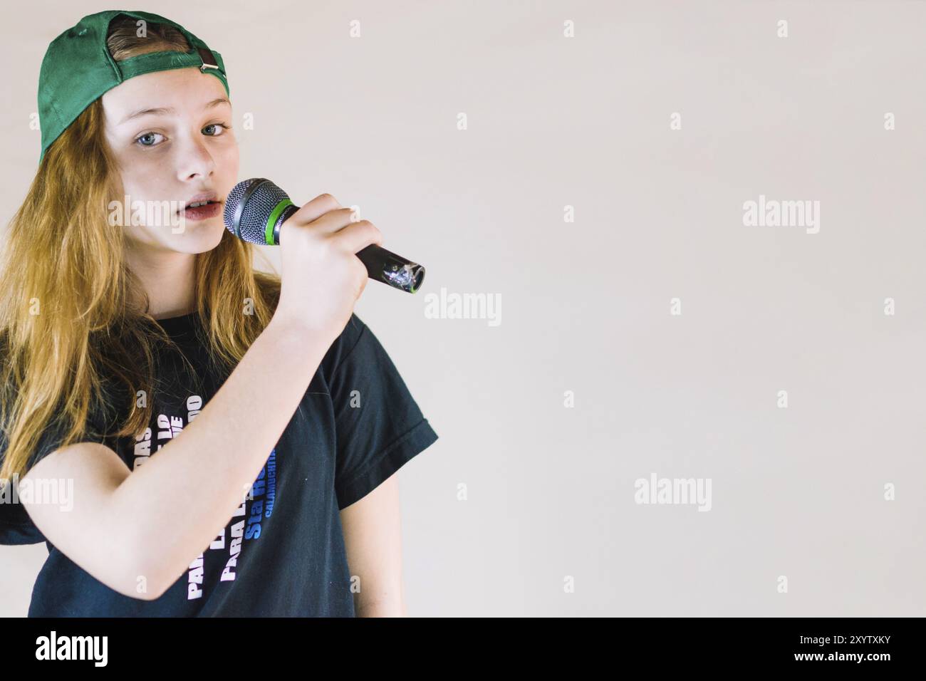 Close up girl singing song with microphone colored background Stock ...