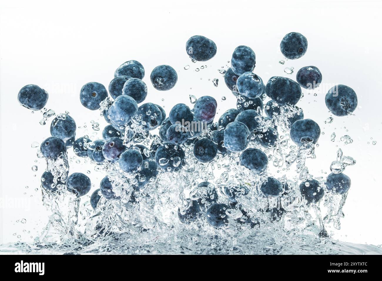 Blueberries sinking into water with air bubbles white background Stock ...