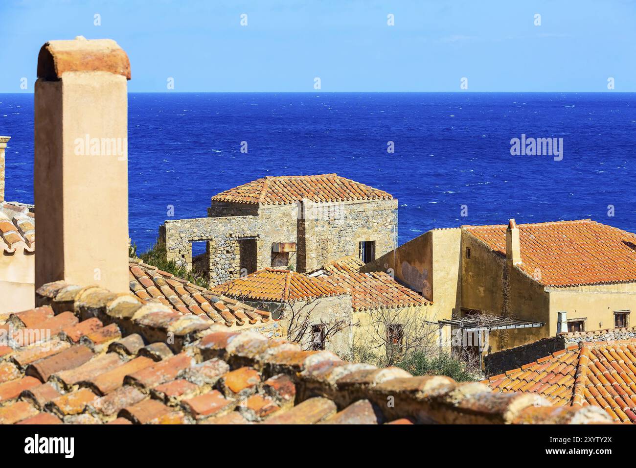 Monemvasia old red brick houses, roofs in ancient town and blue sea ...
