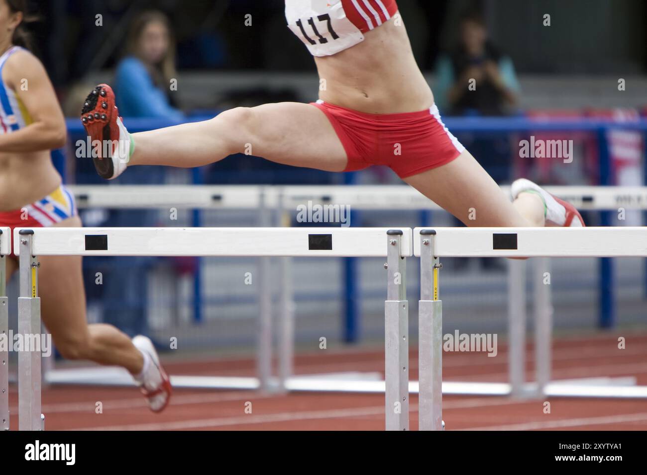 Athletes in the hurdle race Stock Photo - Alamy
