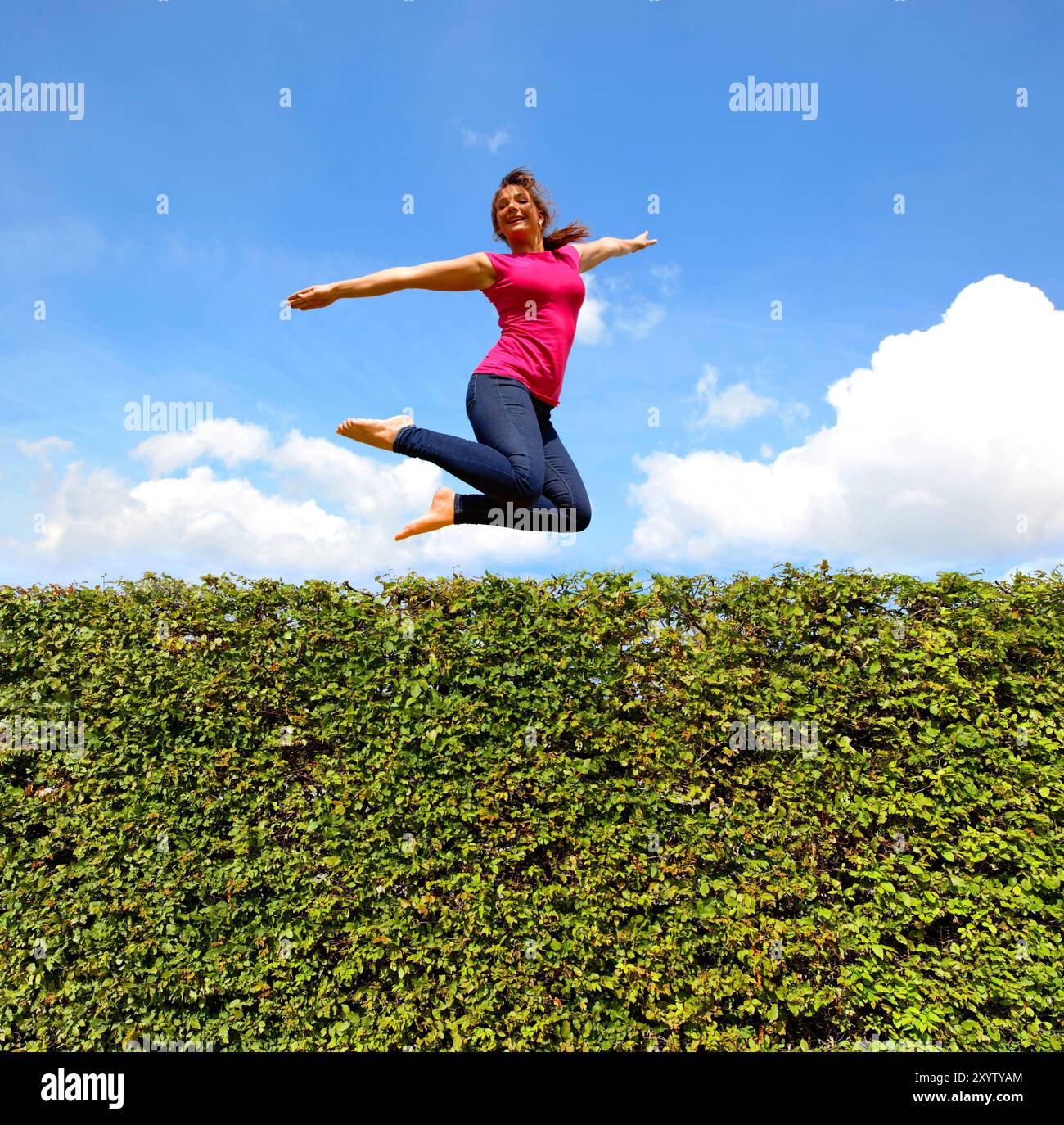 Jumping woman hedge hi-res stock photography and images - Alamy