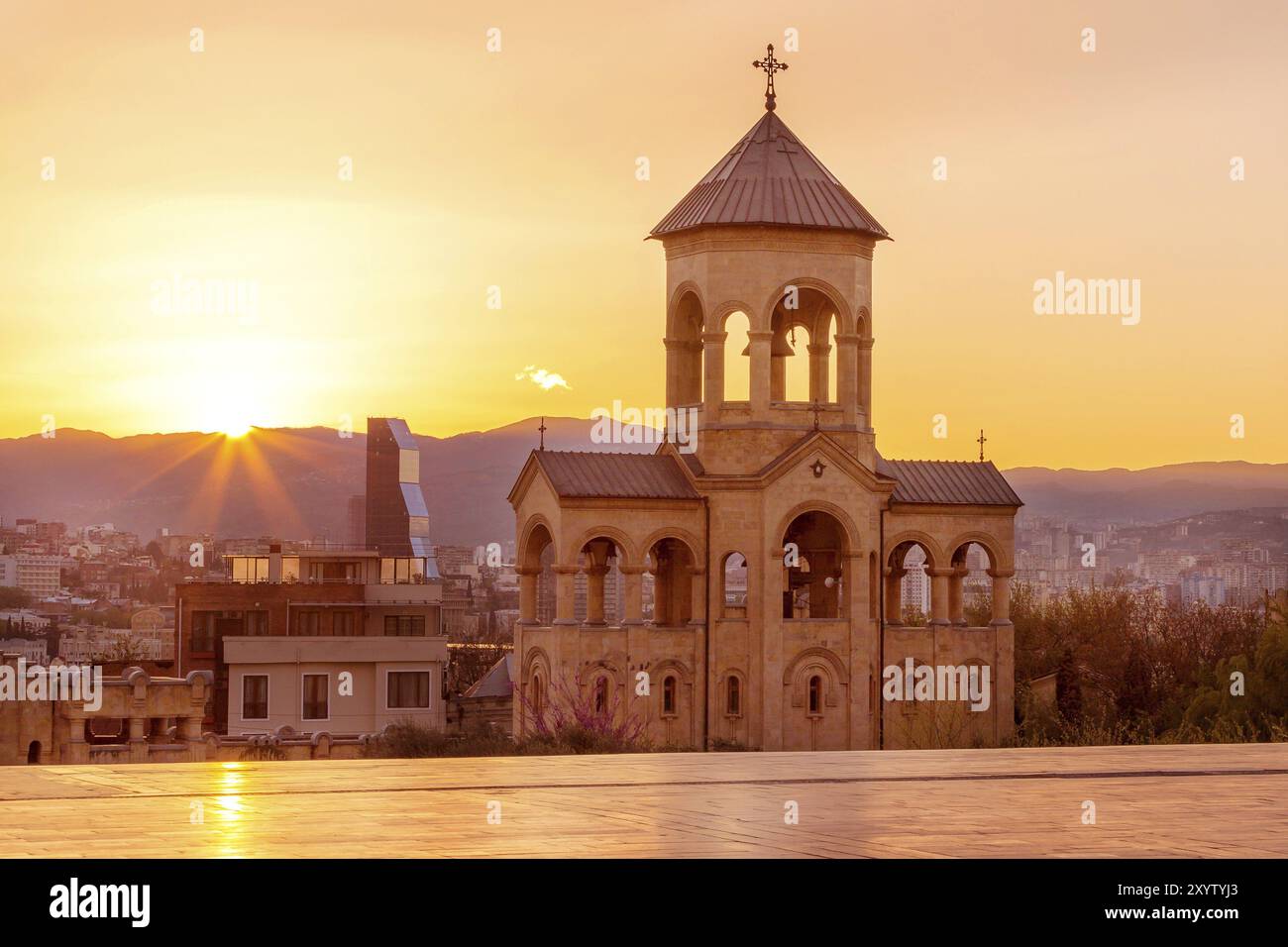 Bell tower of Holy Trinity church or Tsminda Sameba Cathedral sunset ...