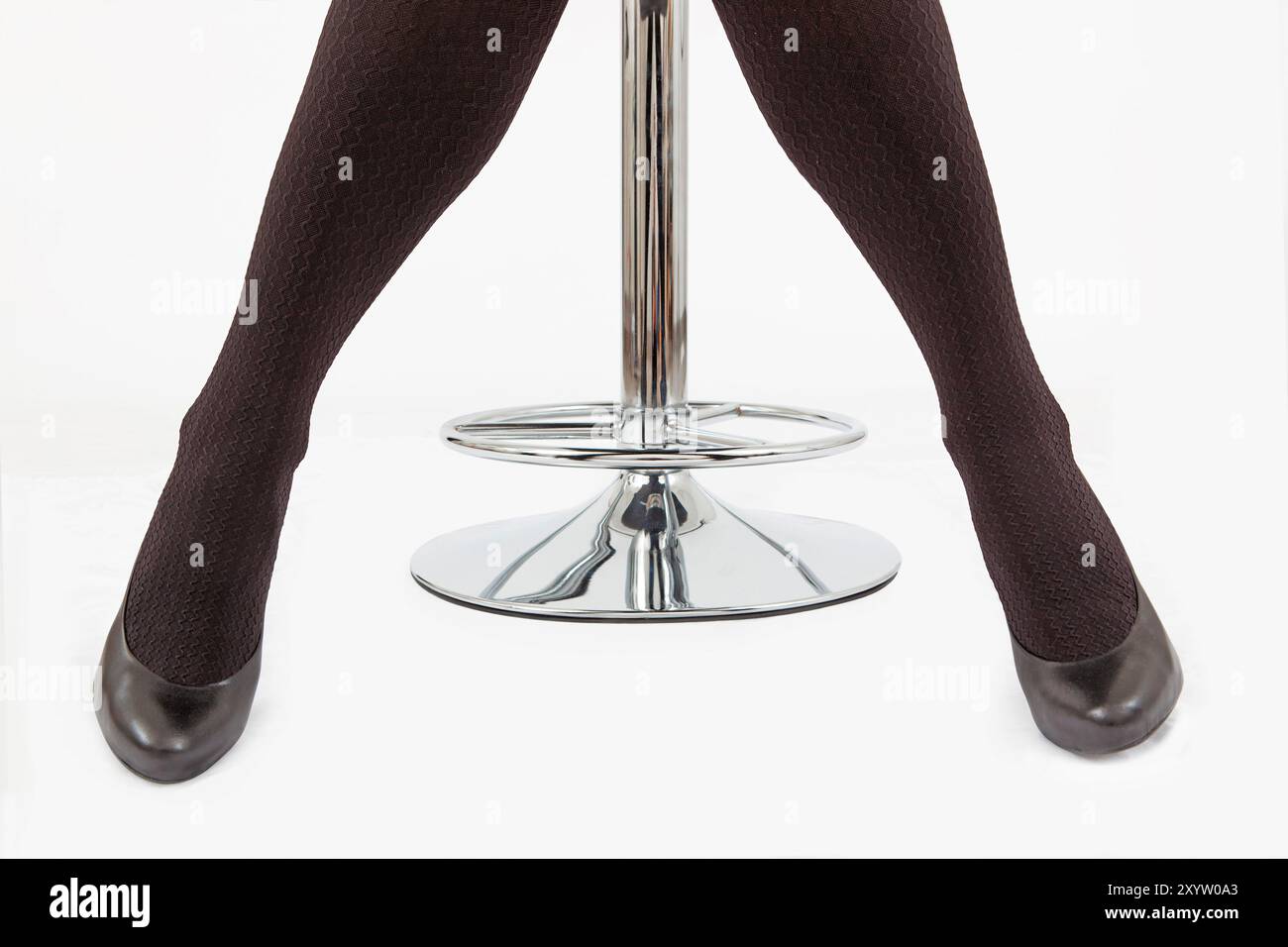 Woman sitting on a bar stool Stock Photo - Alamy