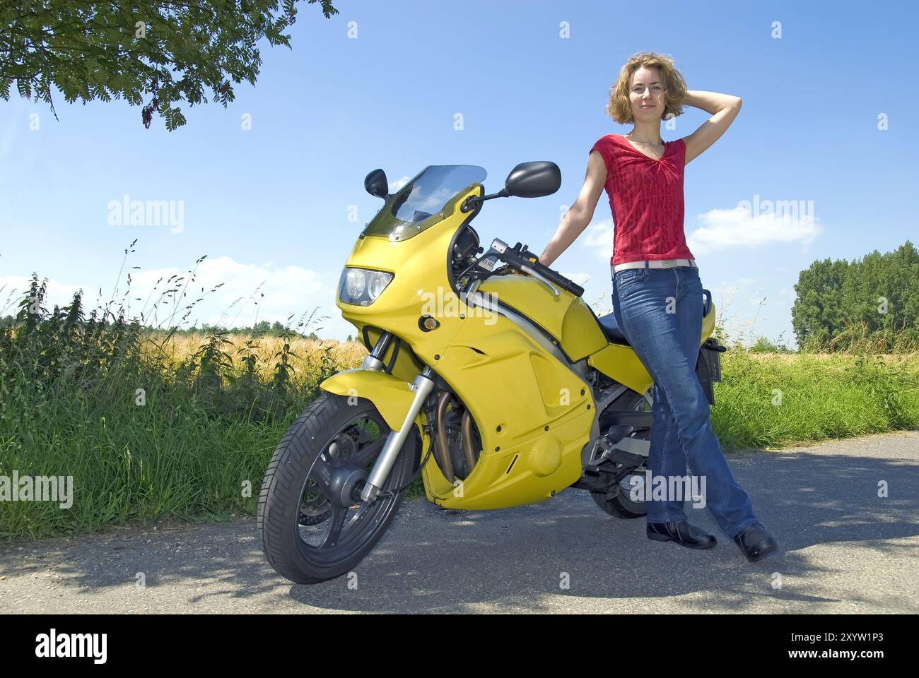 Woman leaning against motorcycle hi-res stock photography and images ...