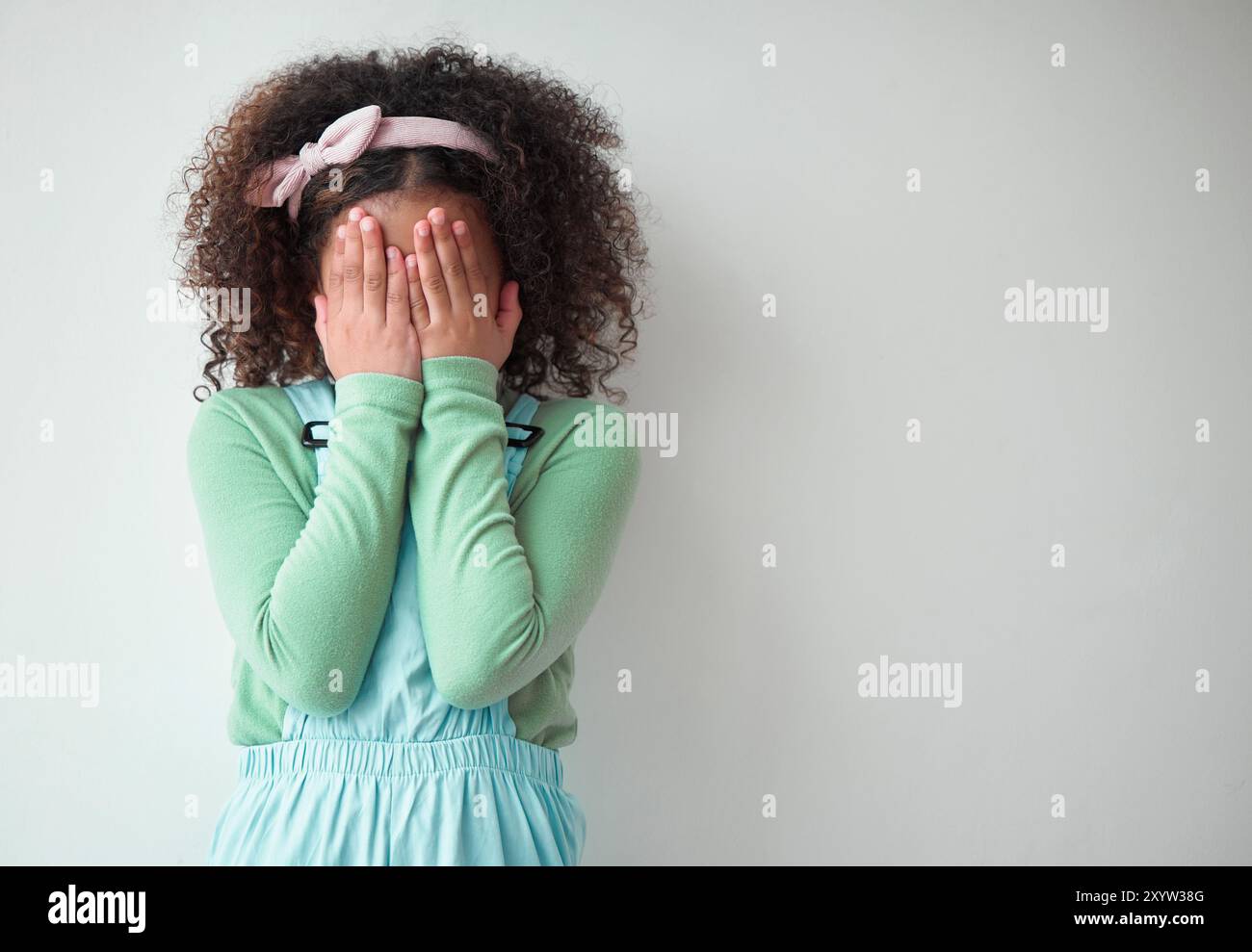 Cover eyes, girl and kid with fear, shy and afraid with reaction on ...