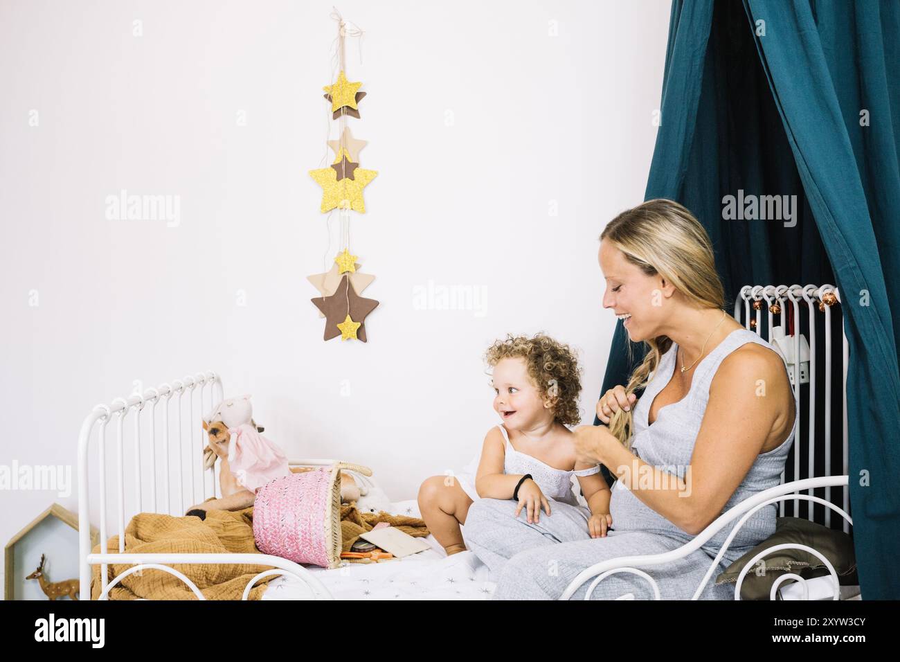 Cheerful pregnant mother baby bed Stock Photo - Alamy
