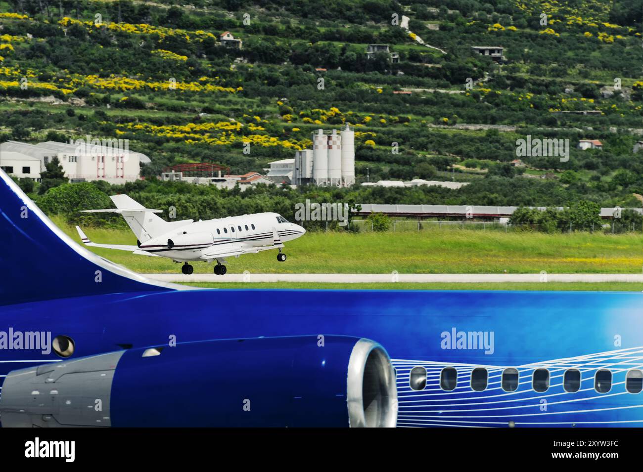 Learjet taking off behind an MD-90 at Split Airport Stock Photo - Alamy