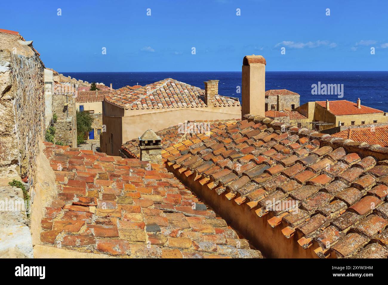 Monemvasia old red brick houses, roofs in ancient town and blue sea ...