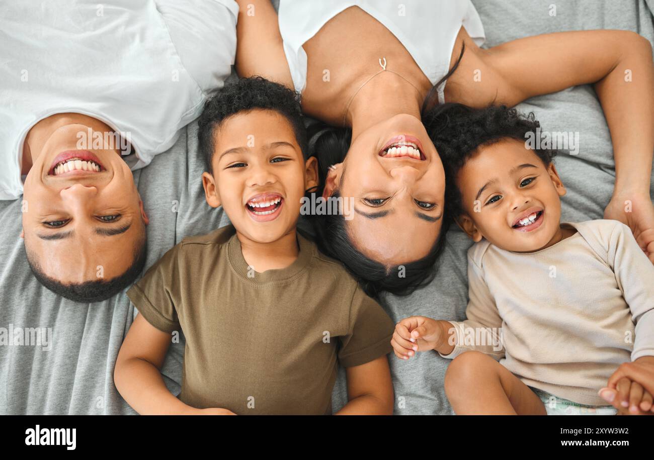Happy, portrait and children with parents on bed for bonding, fun and ...