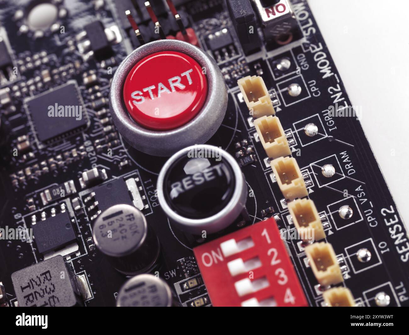 Start and Reset buttons on computer motherboard closeup on white ...