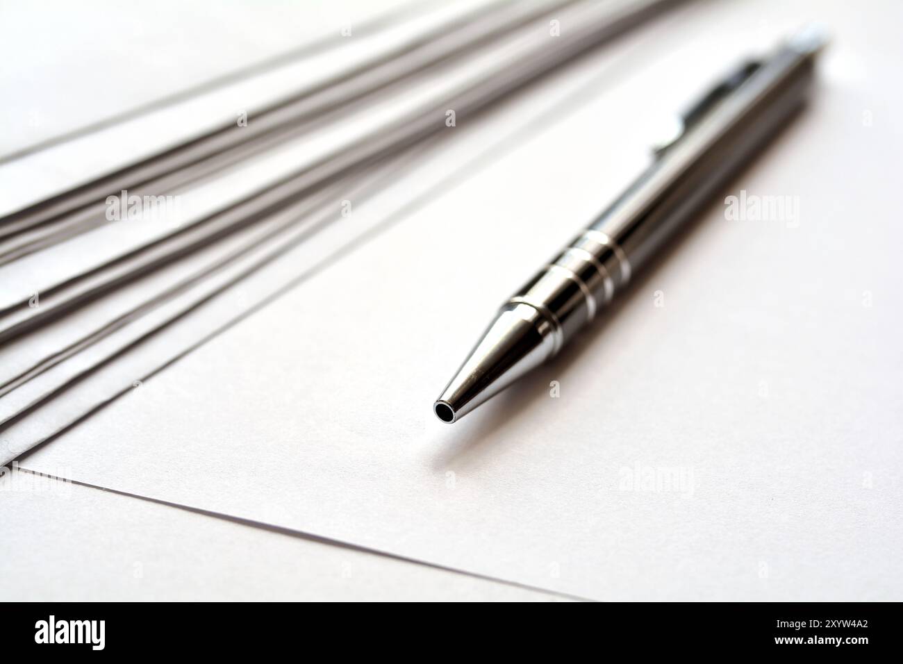 Unwritten writing paper and a biro lie on a table Stock Photo - Alamy