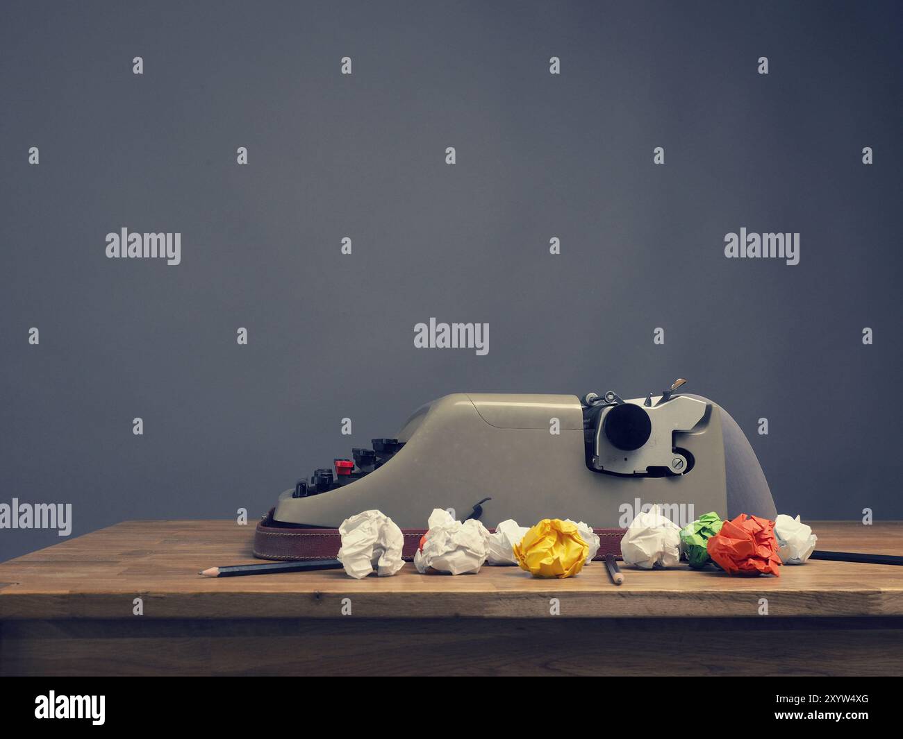 Crumpled paper with an old typewriter on a wooden office desk ...