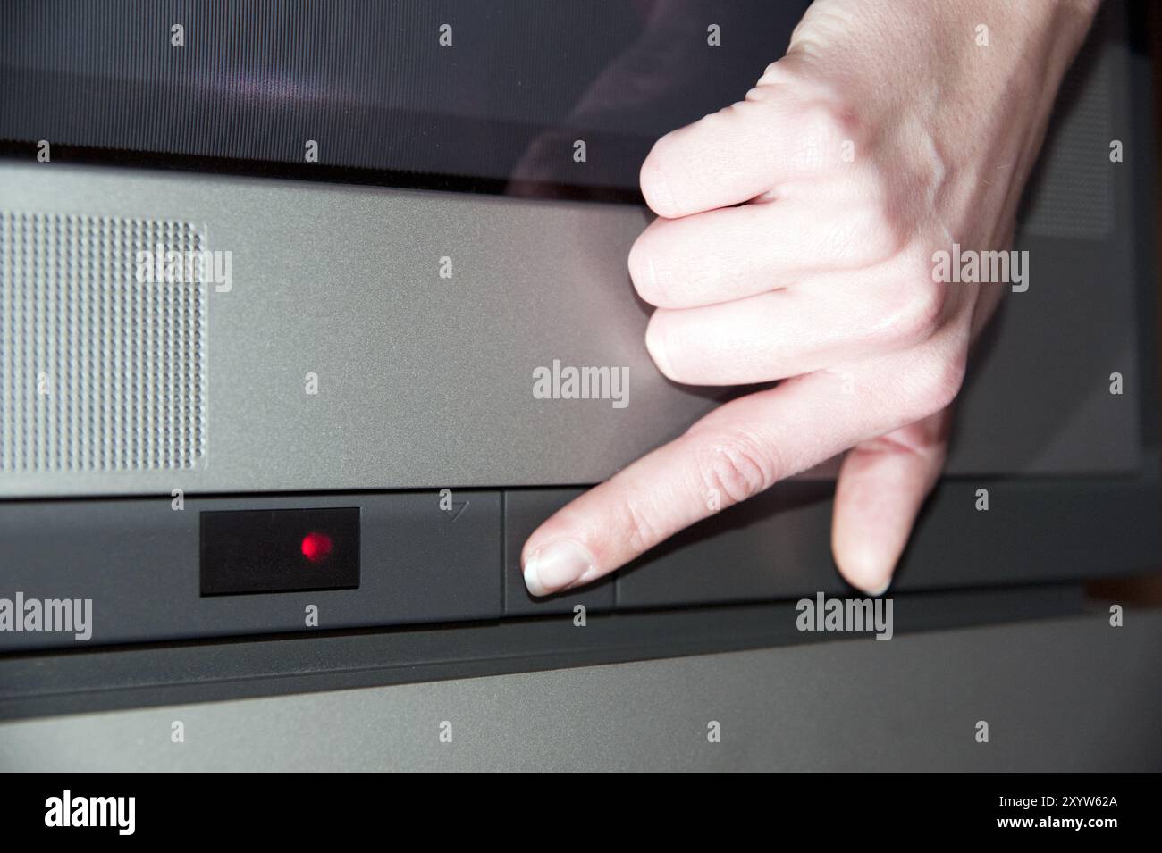 Hand with outstretched index finger switches off electrical device ...