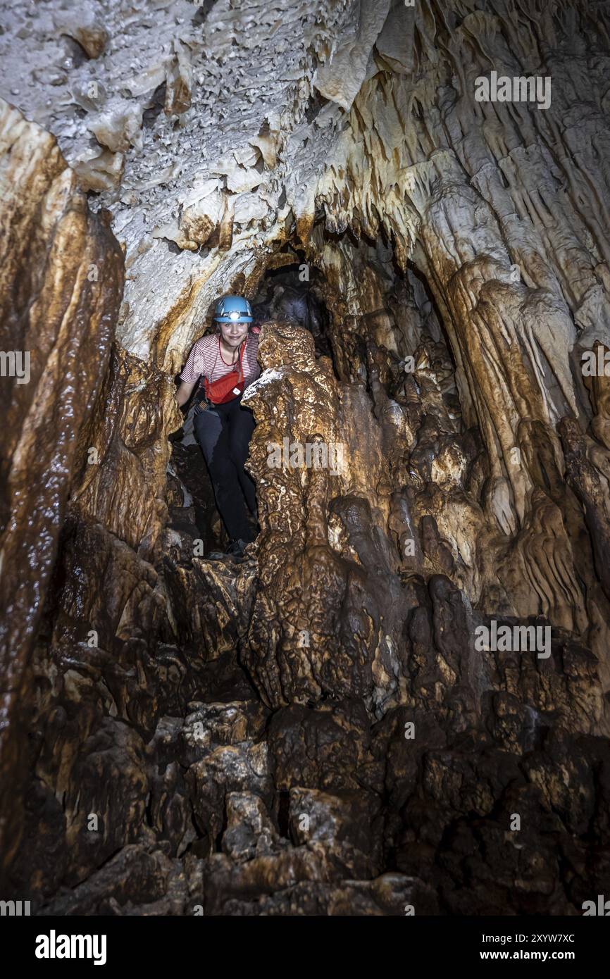 Woman exploring stalactite cave, Terciopelo Cave, Barra Honda National ...