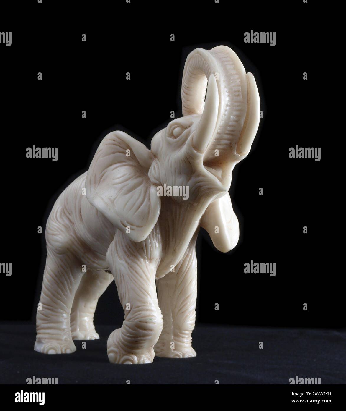 Elephant model, standing tall against black background Stock Photo - Alamy