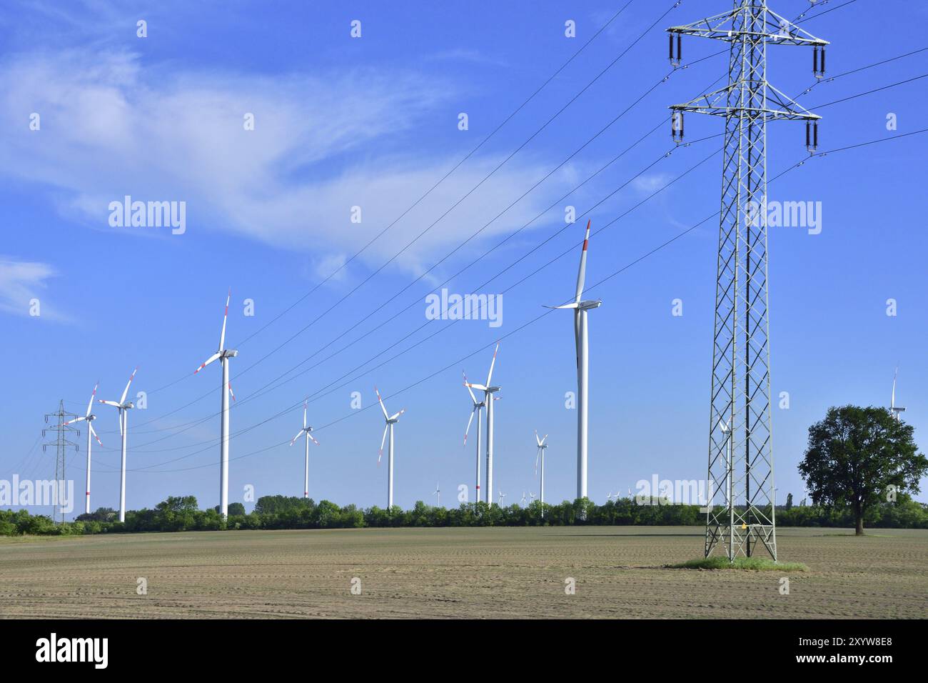 Wind turbines and electricity pylon Stock Photo - Alamy