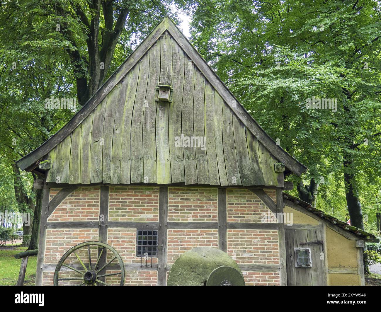 Small historic half-timbered building in the forest with natural stone ...