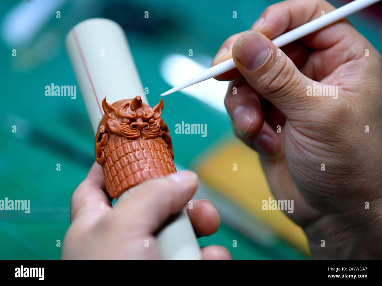 (240831) -- ZHENGZHOU, Aug. 31, 2024 (Xinhua) -- Song Zhanke makes a dough miniature of armour ...