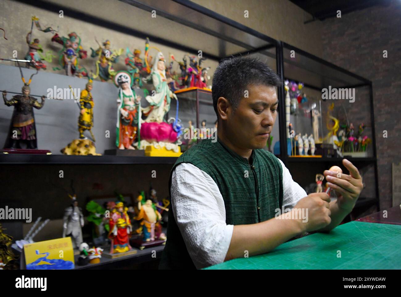 (240831) -- ZHENGZHOU, Aug. 31, 2024 (Xinhua) -- Song Zhanke makes a dough sculpture of Chinese ...