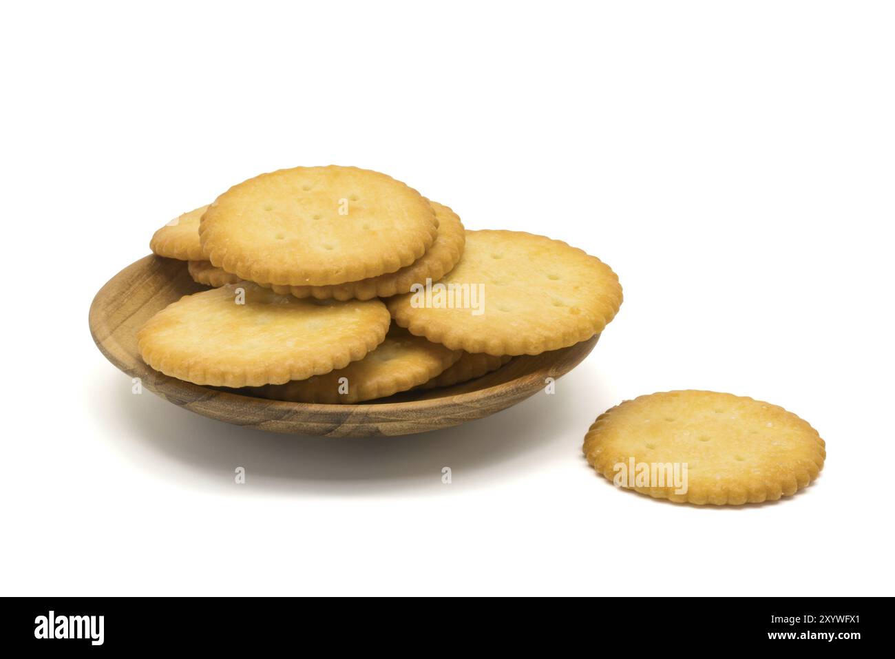 Salted round cracker in a wooden plate on white background Stock Photo ...