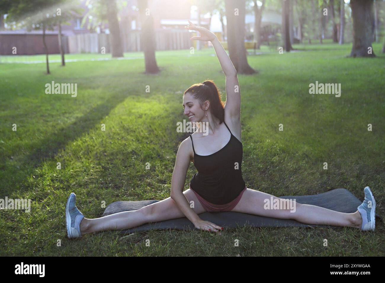 Stretching woman in outdoor exercise smiling happy doing stretches ...