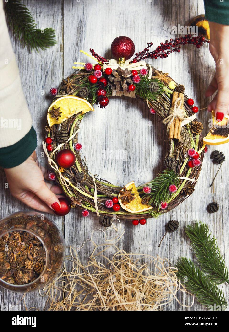 Christmas handmade wreath in young womans hands. Winter holidays ...