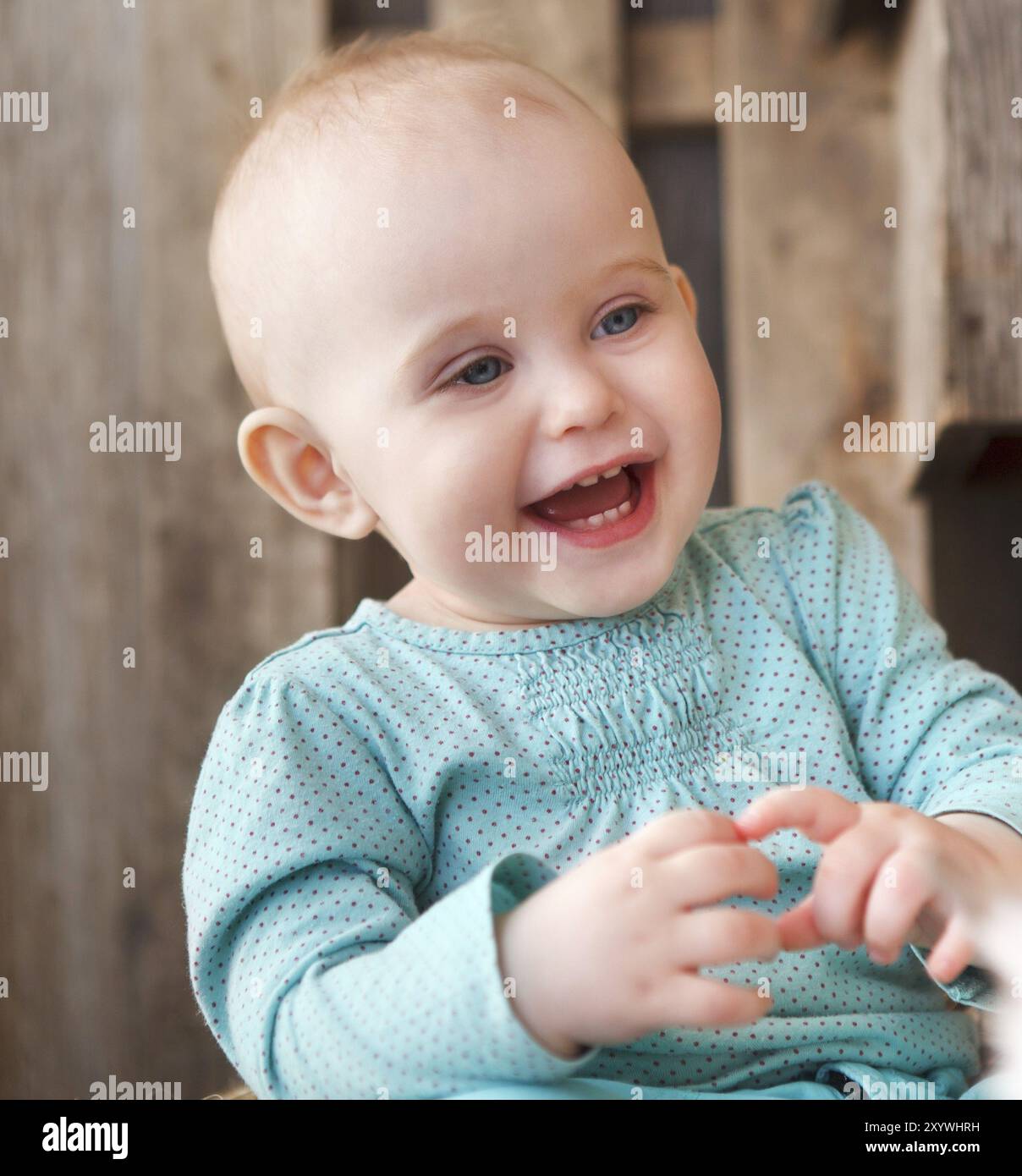 Cute smiling ten month old baby on the wooden background Stock Photo ...