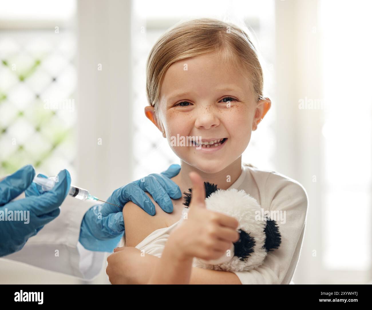 Happy little girl, portrait and injection with thumbs up for doctor ...