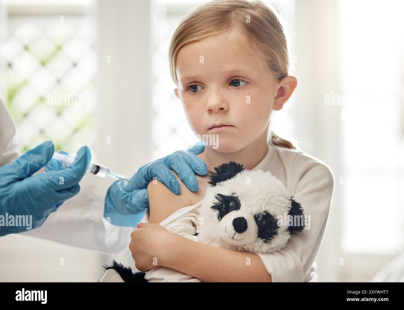 Little girl, needle and injection with doctor for vaccine, medical ...
