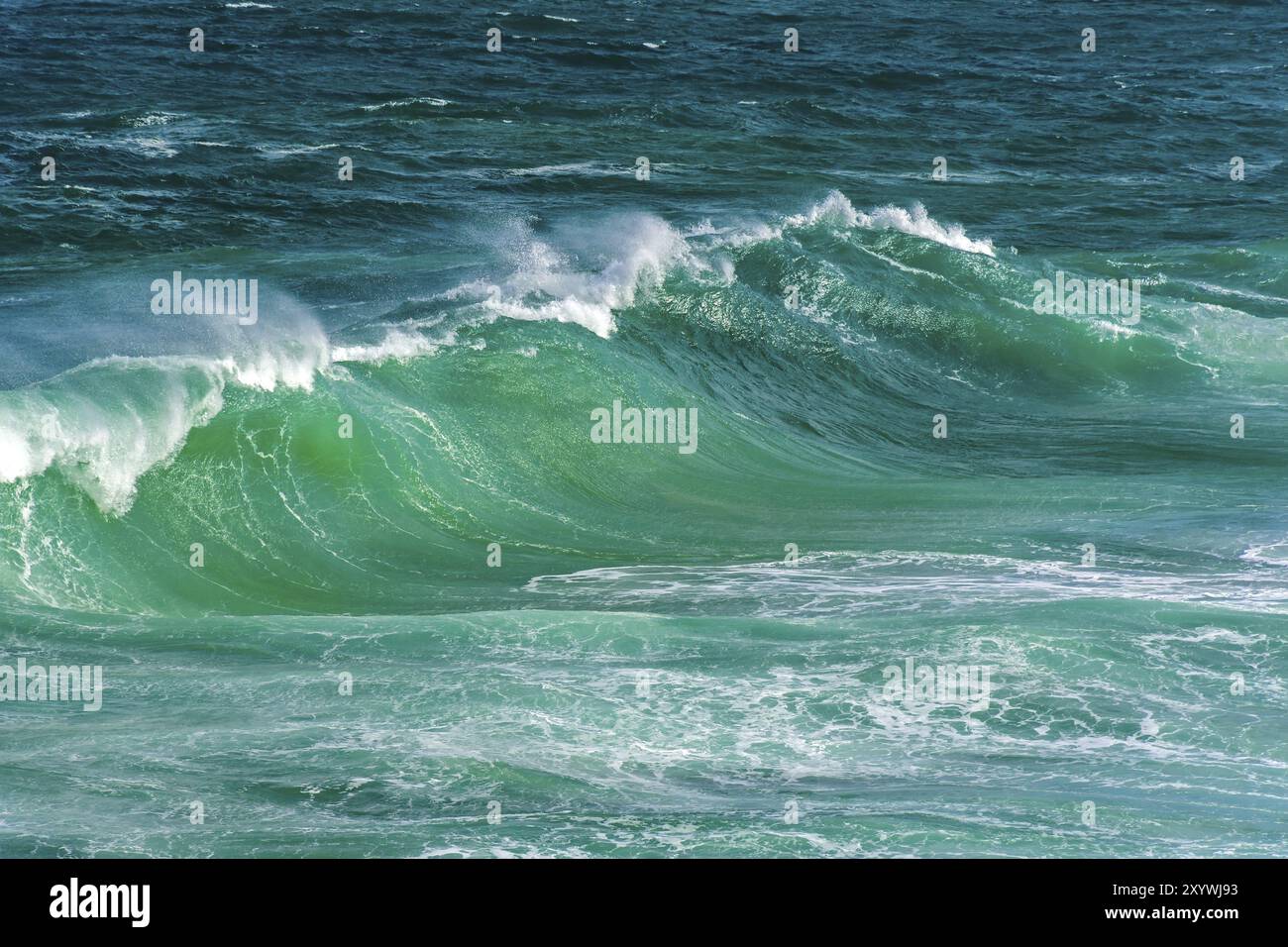 Wave crashing against rocks during storm Stock Photo - Alamy