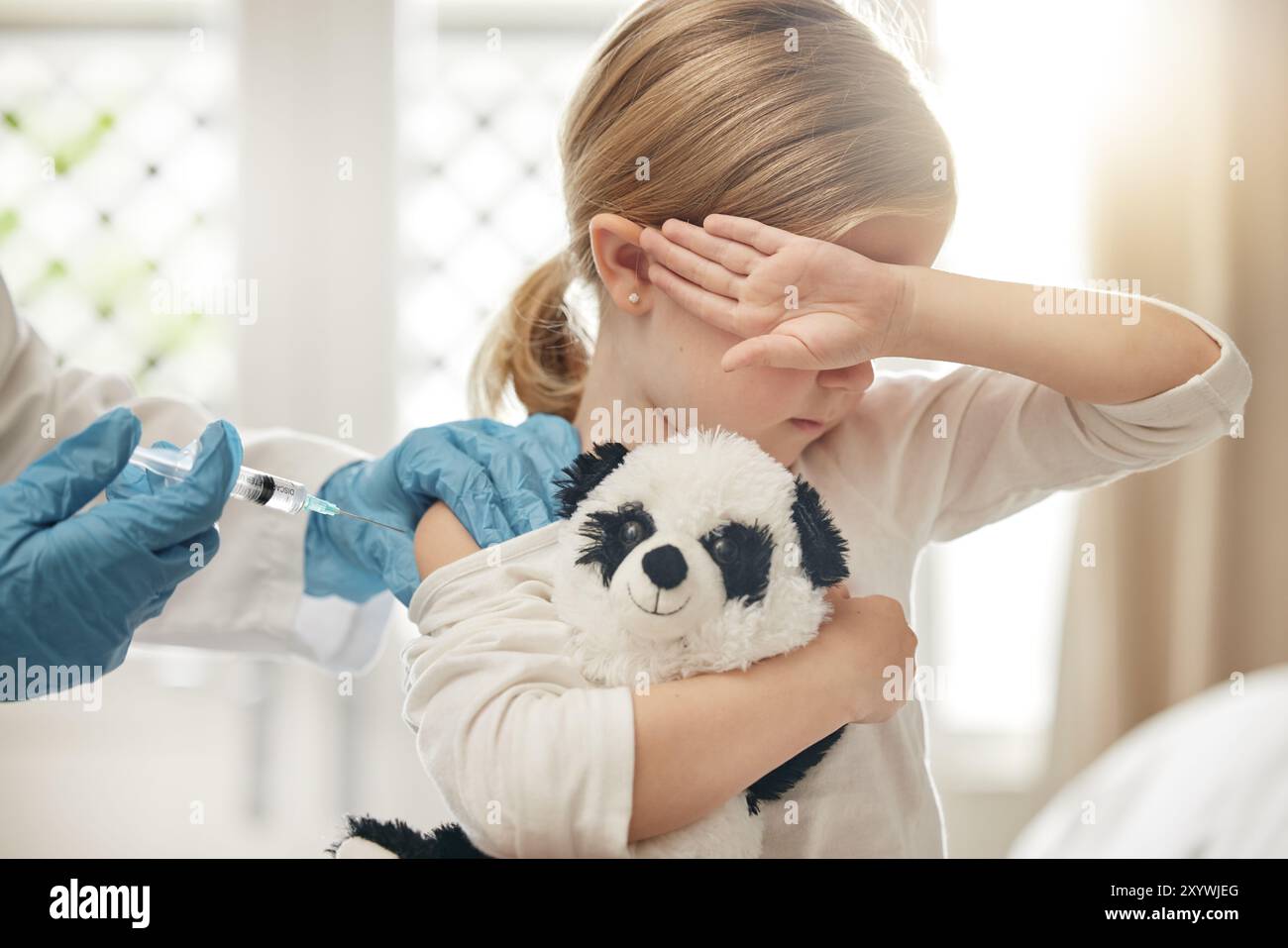 Scared girl, needle and injection with doctor for vaccine, cure or ...