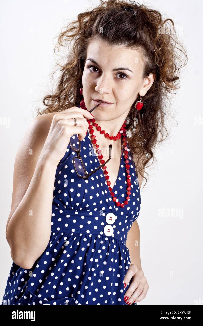 Beautiful woman in a blue polka dot dress with glasses Stock Photo - Alamy