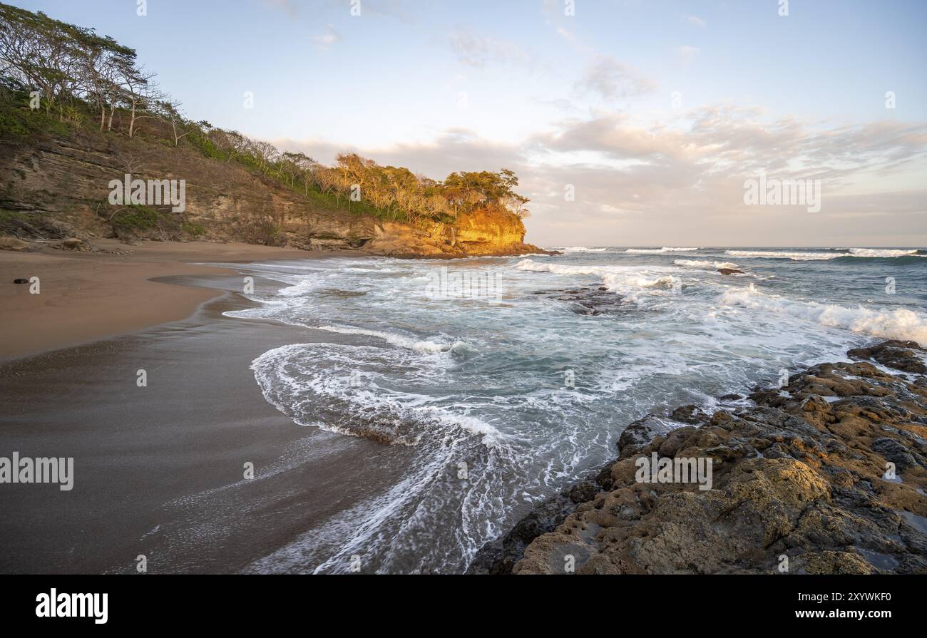 Sandy beach beach with rocks and sea at sunset, Playa Cocalito, coastal ...