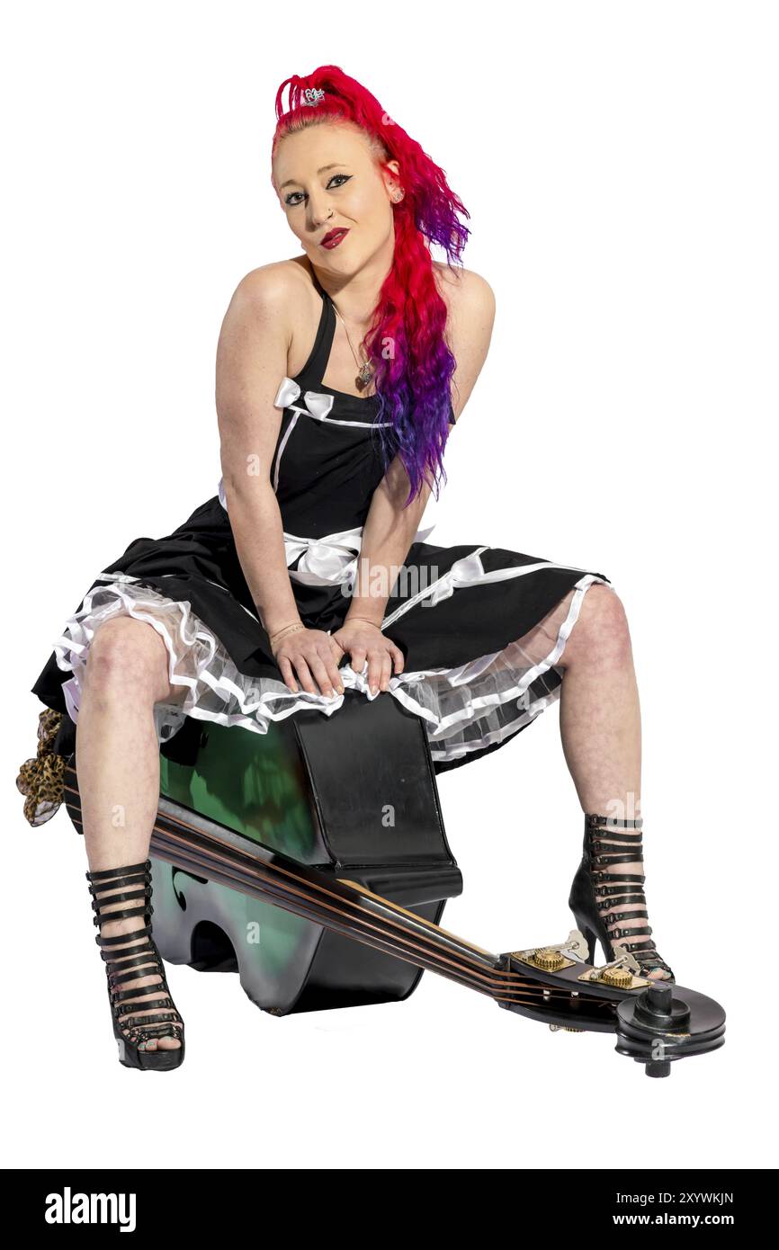 Rock'n'roll singer with red hair sits on a double bass Stock Photo - Alamy