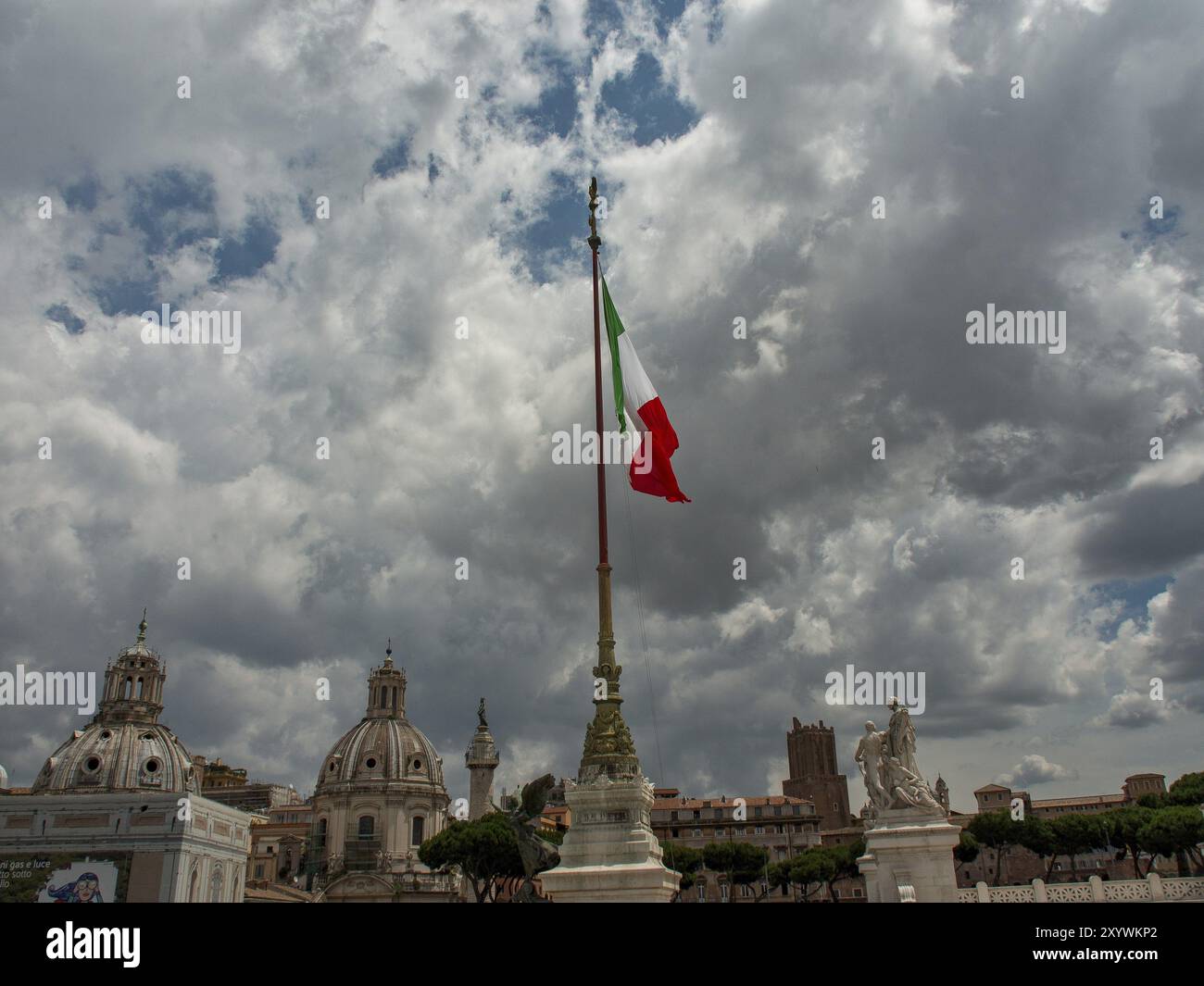 Italian national flag in front of historical buildings and statues ...
