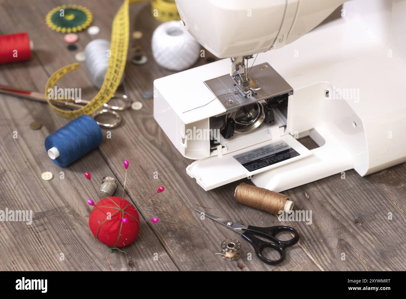 Seamstress or tailor background with sewing tools, colorful threads ...